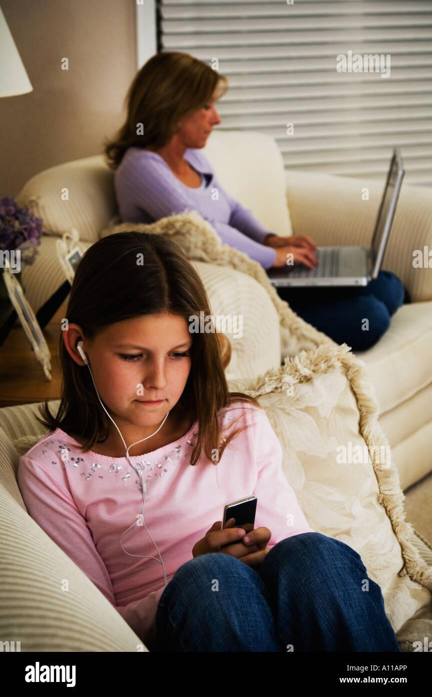 Mom and daughter using electronics Stock Photo - Alamy