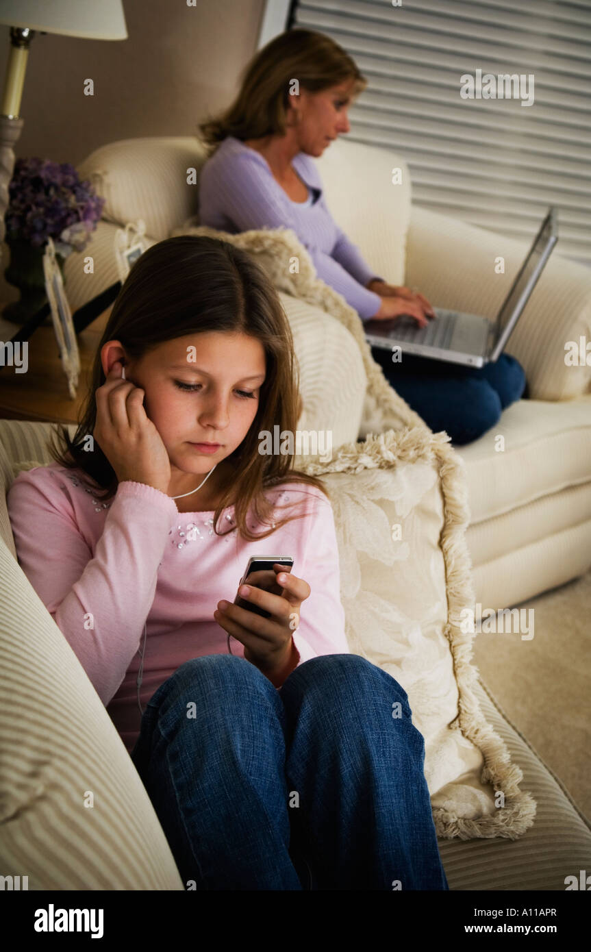 Mom and daughter using electronics Stock Photo - Alamy