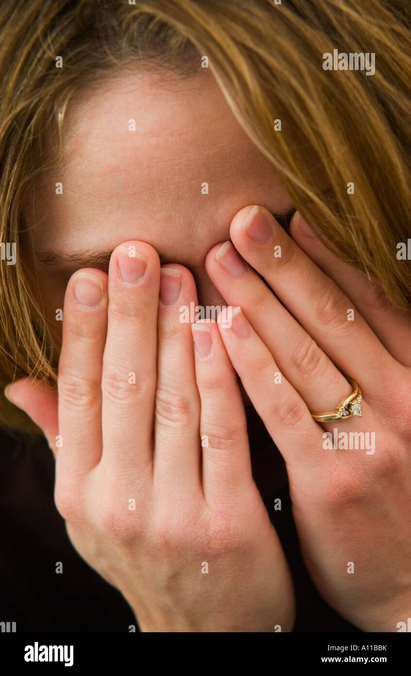 Woman covering eyes Stock Photo - Alamy