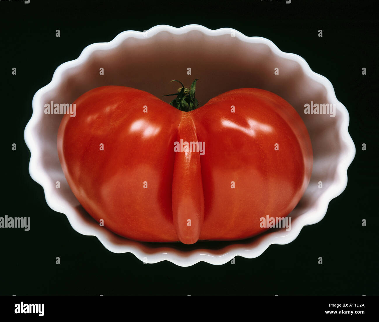 Tomato with nose in white porcelain bowl Stock Photo - Alamy