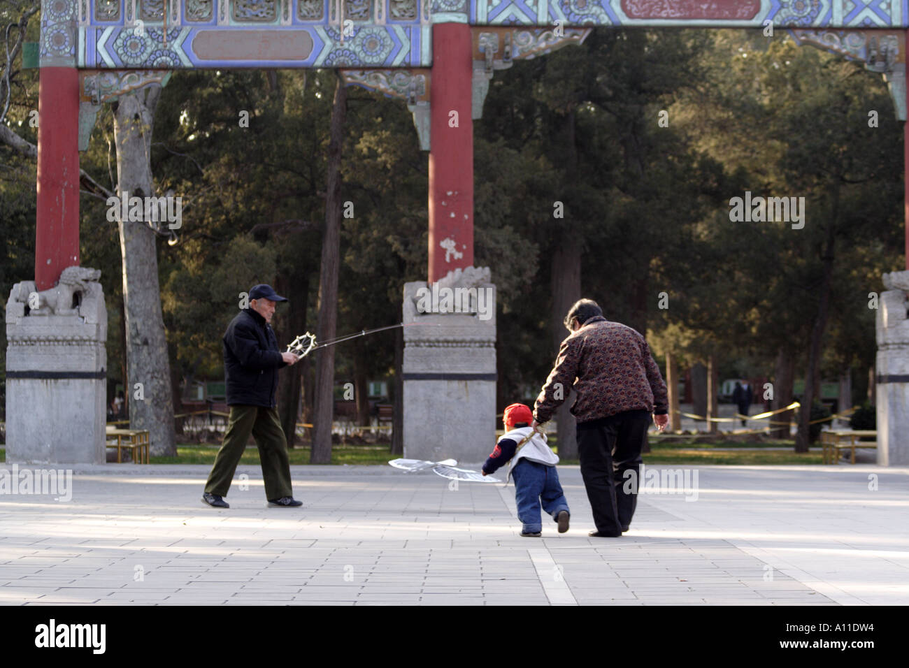 Elderly man with a kite on a rod and reel in Jingshan Park, baby ...