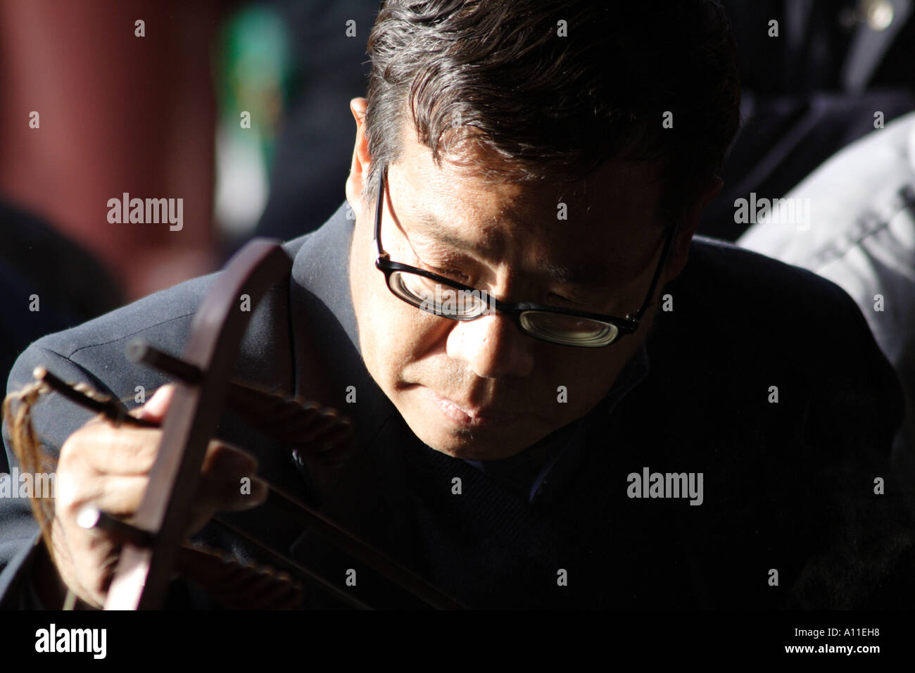 Man playing traditional instrument in Temple of Heaven Park. Beijing ...