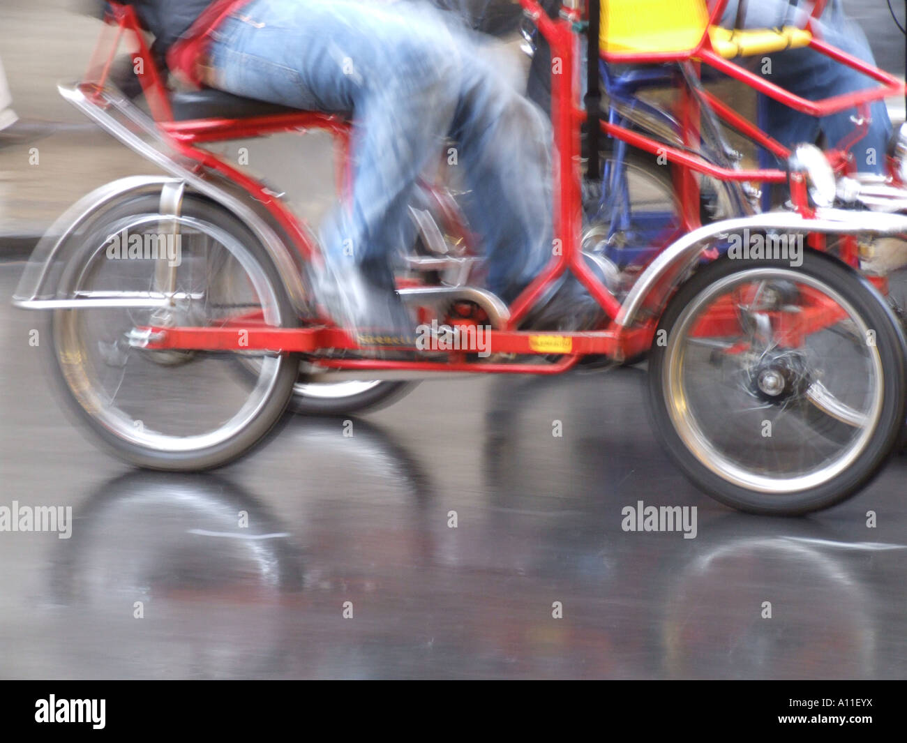 people in rickshaw type bike in rain Stock Photo - Alamy
