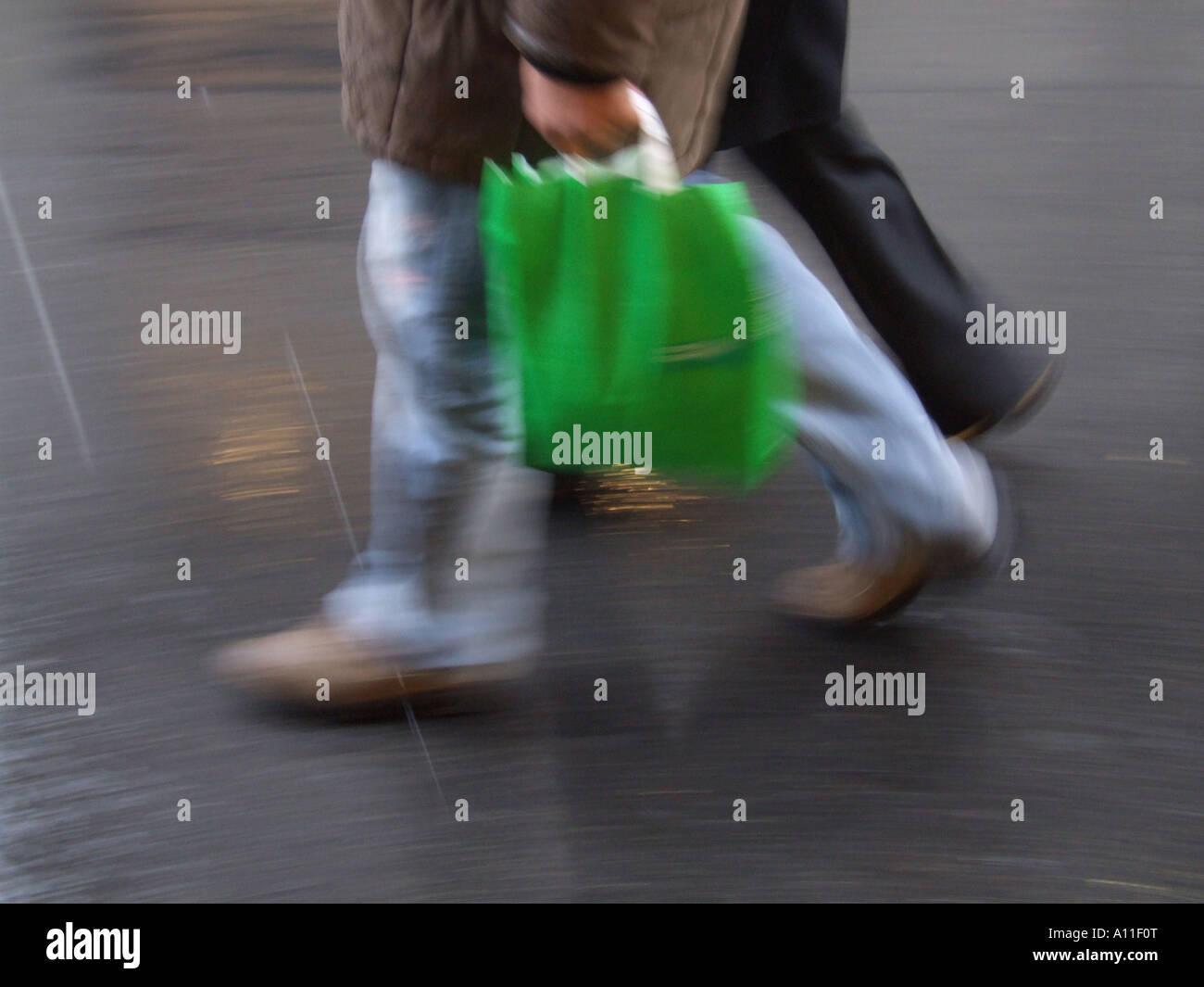 man walking with shopping bag blurred Stock Photo - Alamy