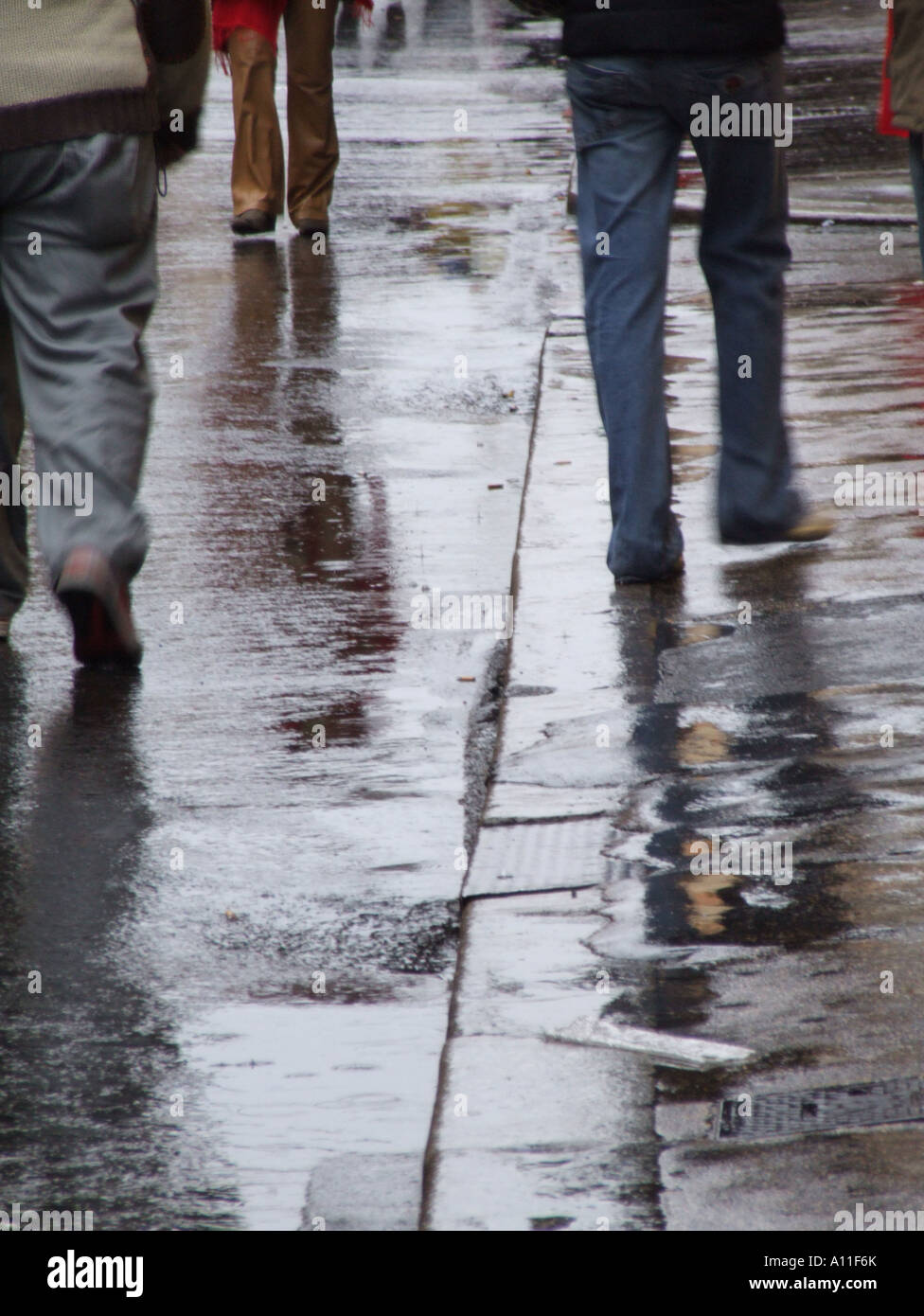 person walking in rain in town Stock Photo - Alamy