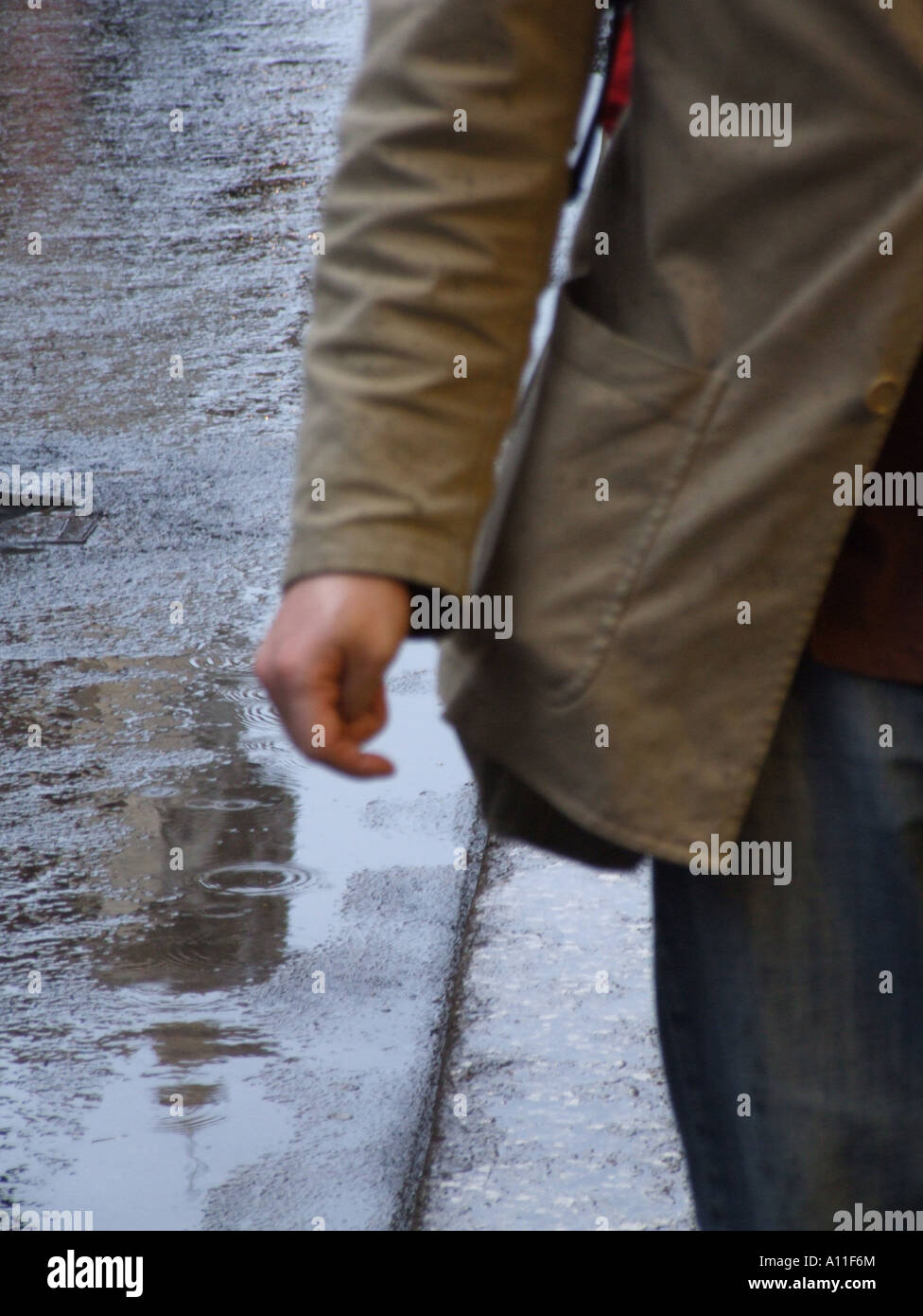 person walking in rain in town Stock Photo - Alamy