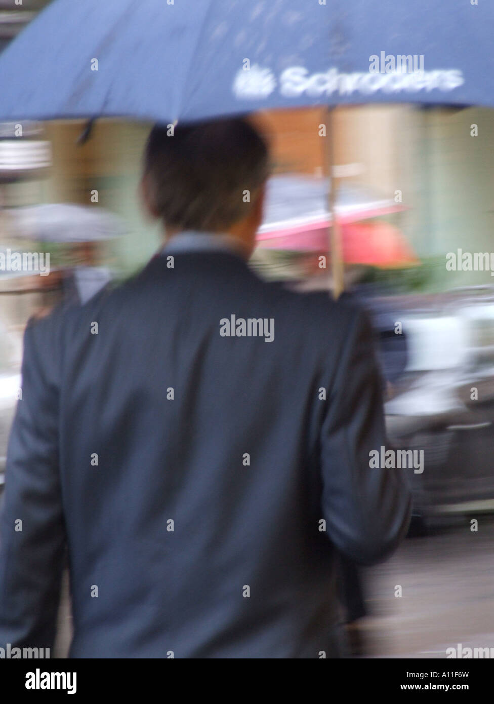 person walking in rain on busy city street Stock Photo - Alamy