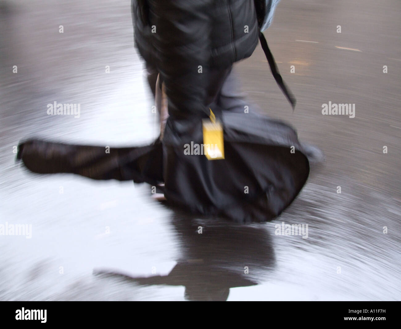 person walking in rain in town Stock Photo - Alamy