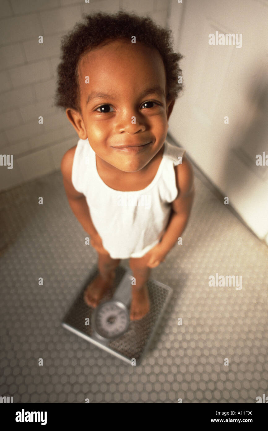 Boy standing on bathroom scale hi-res stock photography and images - Alamy