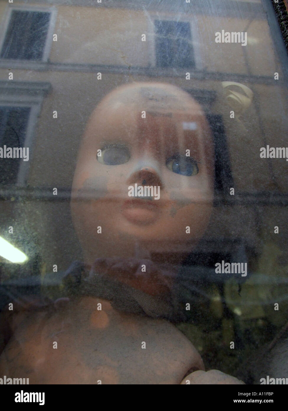 old doll in window Stock Photo - Alamy