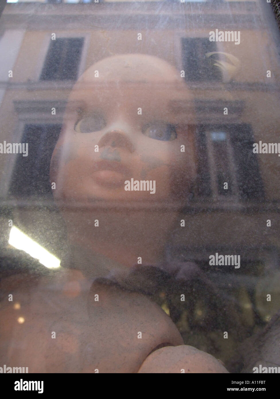 old doll in window Stock Photo - Alamy