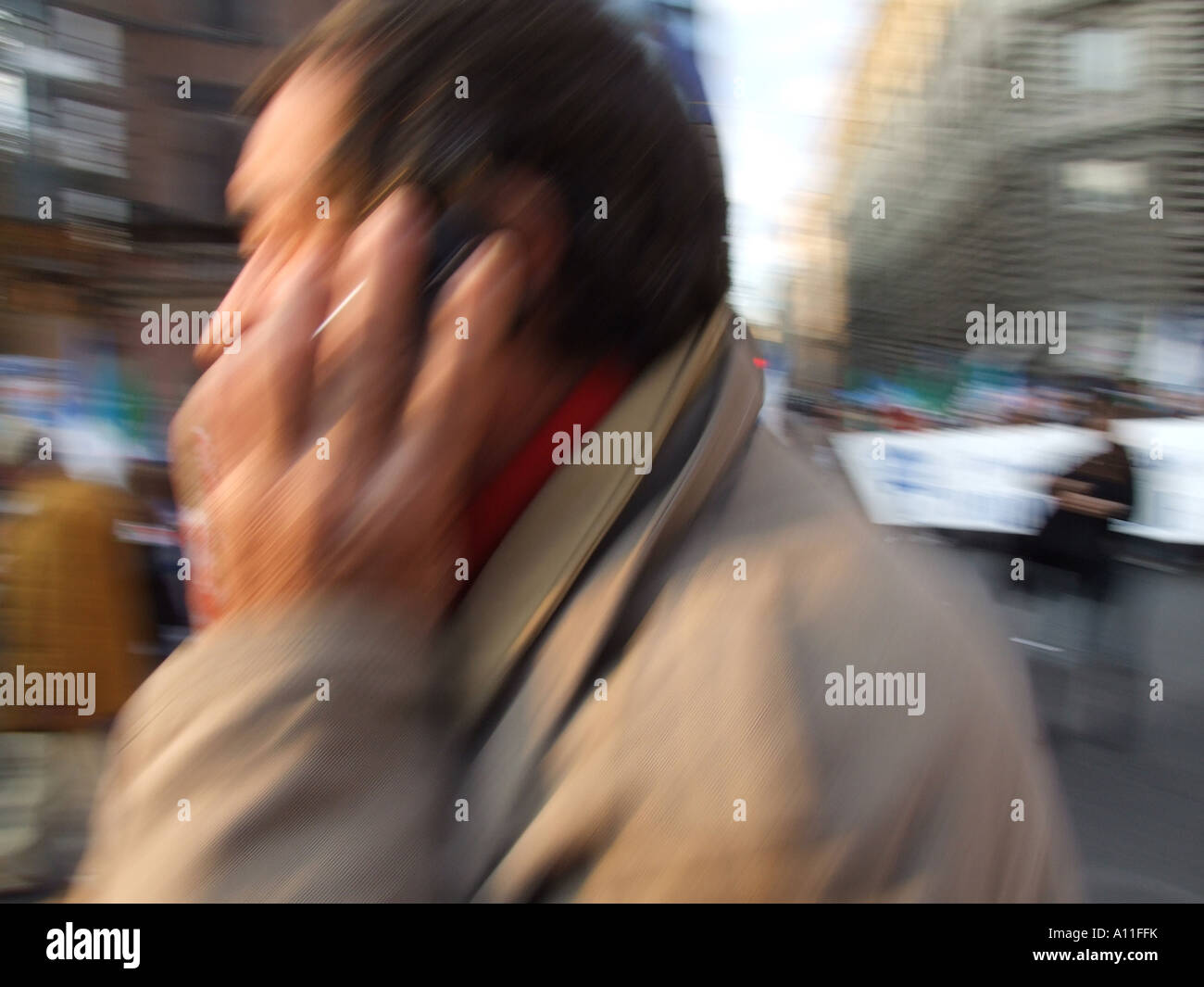 man rushing by with mobile phone Stock Photo - Alamy