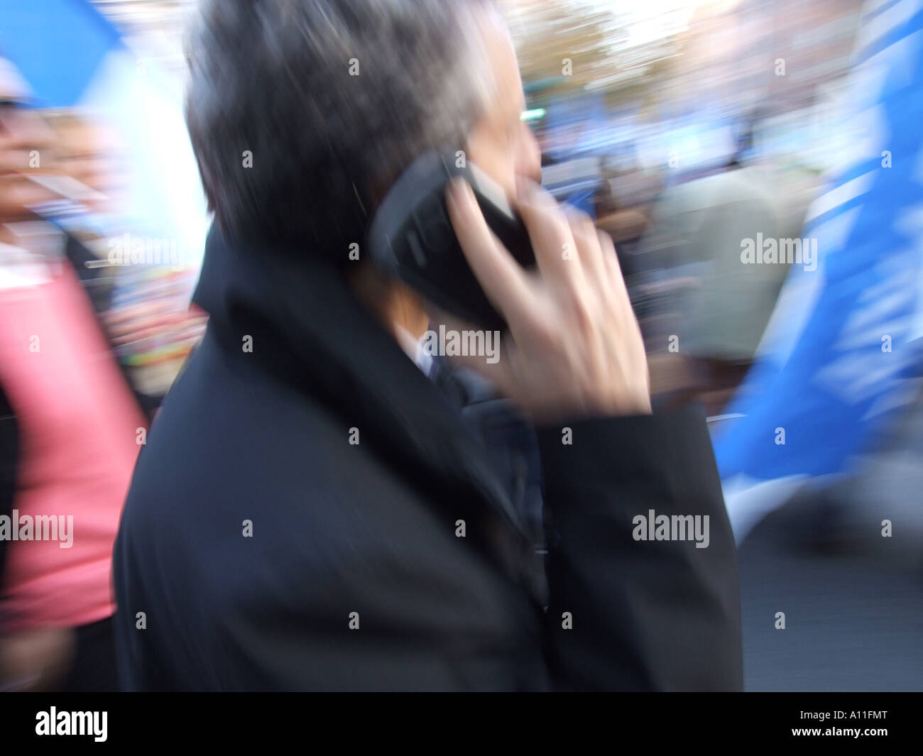 man rushing by with mobile phone Stock Photo - Alamy