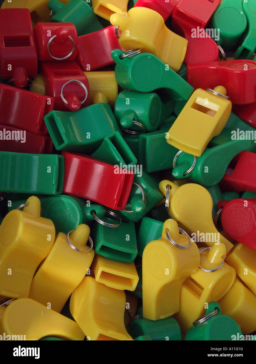 box of colourful plastic whistles Stock Photo - Alamy