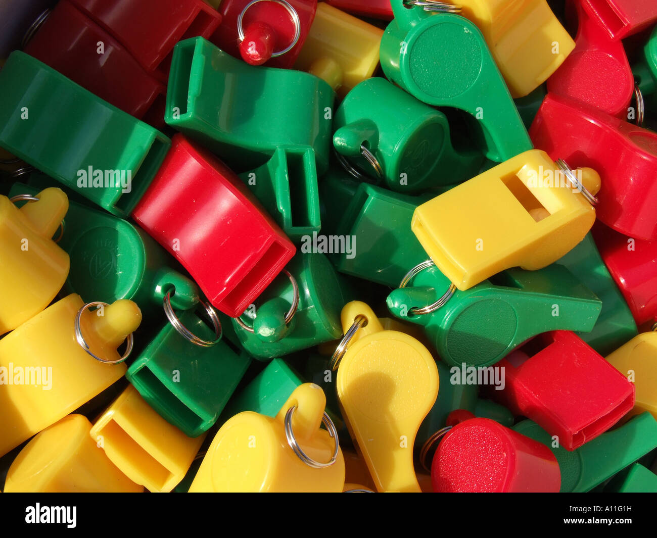 box of colourful plastic whistles Stock Photo - Alamy