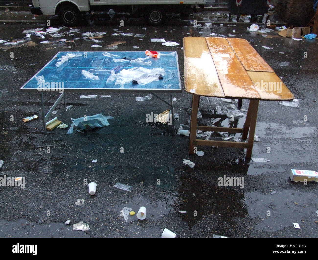 litter on rain soaked empty market stall in town Stock Photo - Alamy