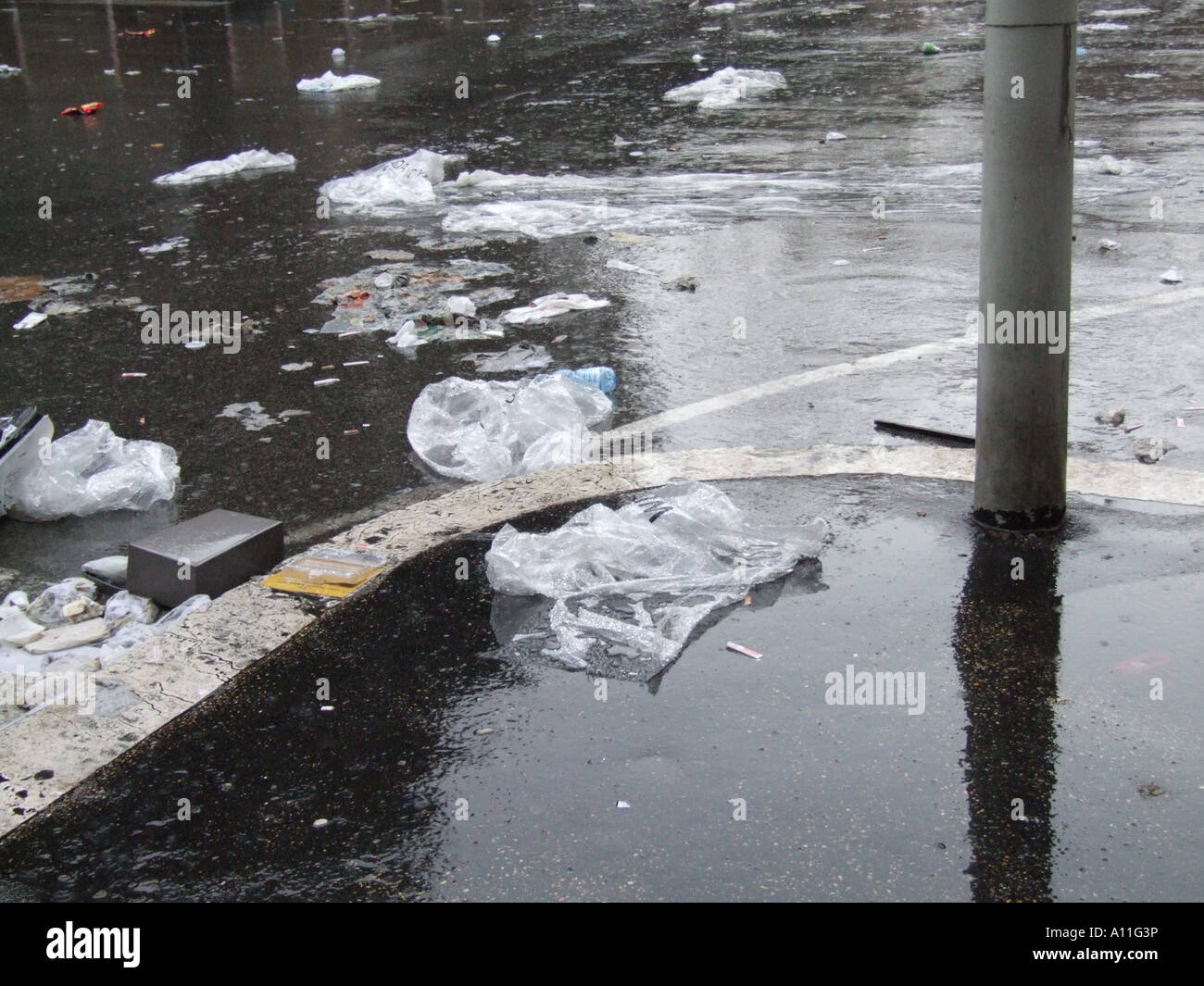 litter on rain soaked street in town Stock Photo - Alamy