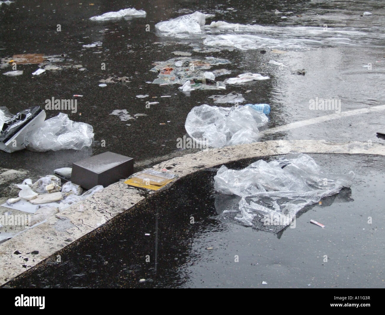 litter on rain soaked street in town Stock Photo - Alamy