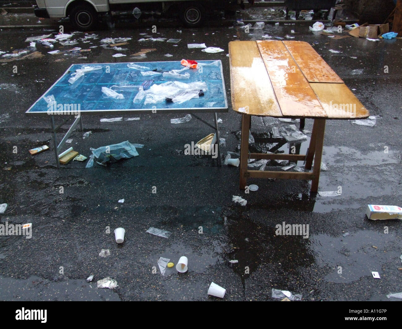 litter on rain soaked empty market stall in town Stock Photo - Alamy