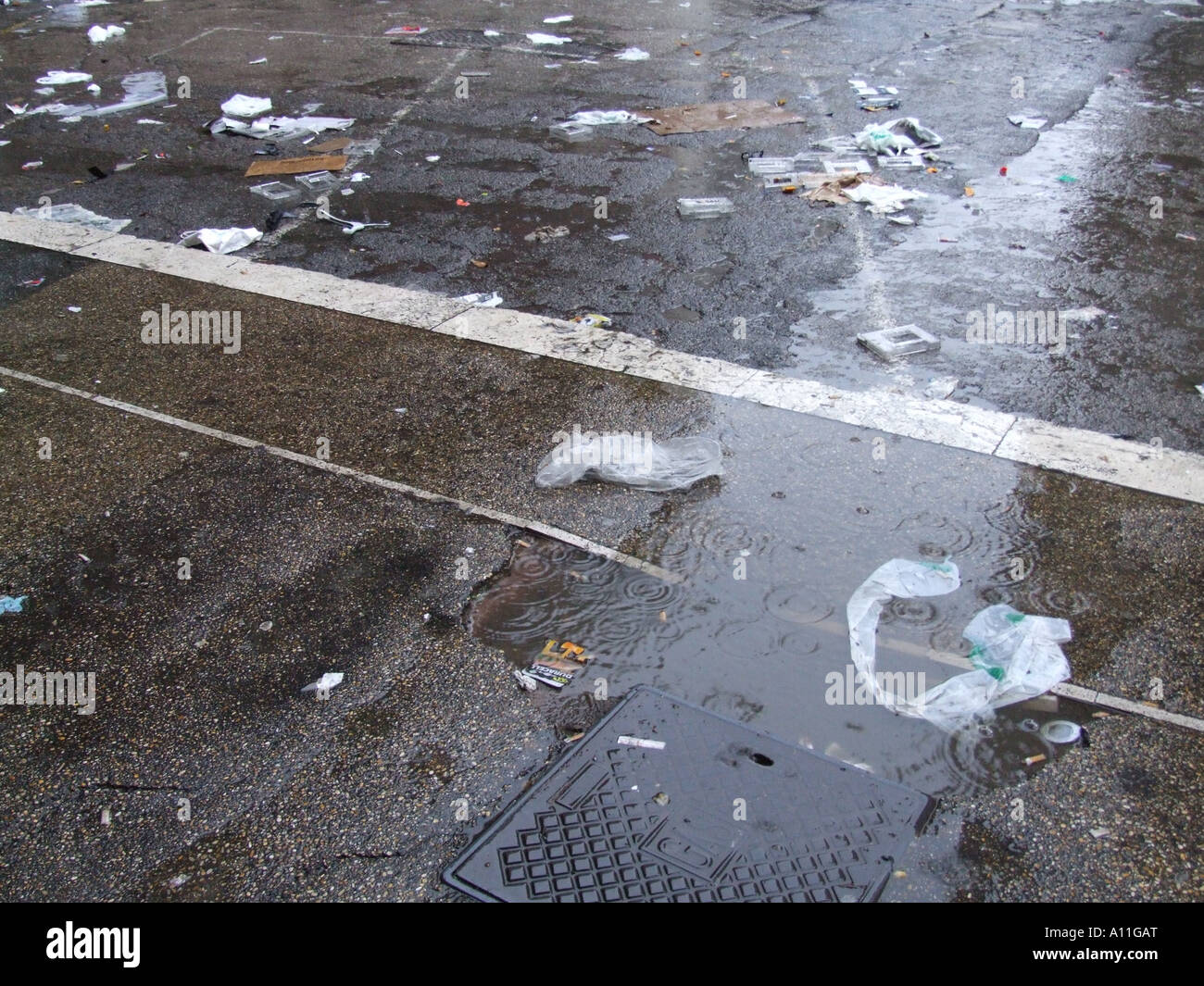 litter on rain soaked street in town Stock Photo - Alamy