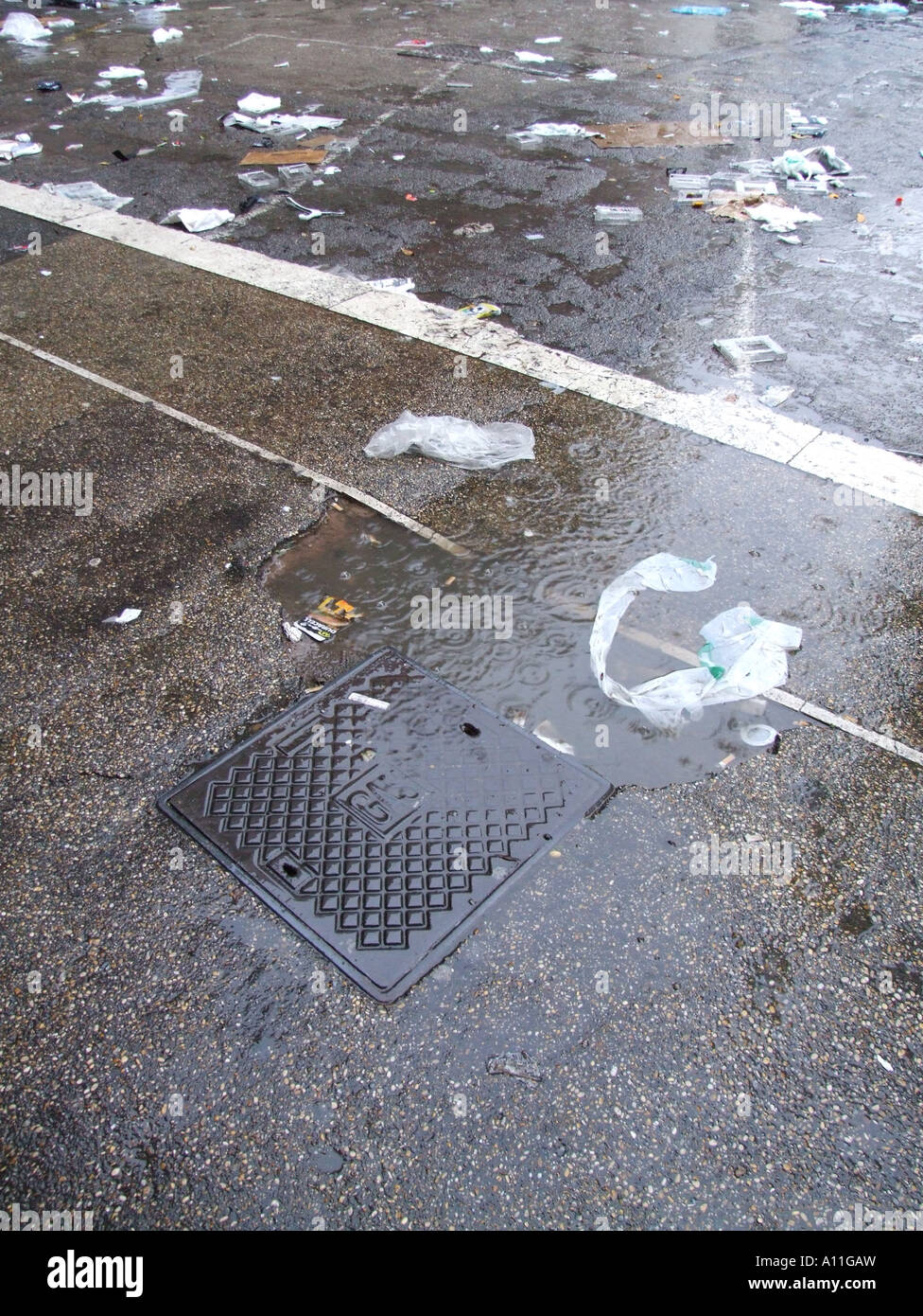 litter on rain soaked street in town Stock Photo - Alamy