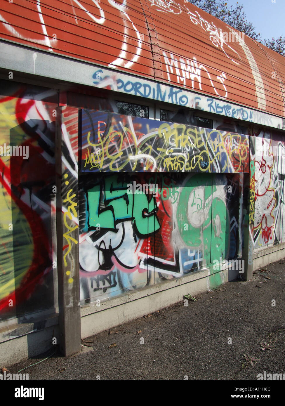 name plate board covered with graffiti in train station in rome Stock ...