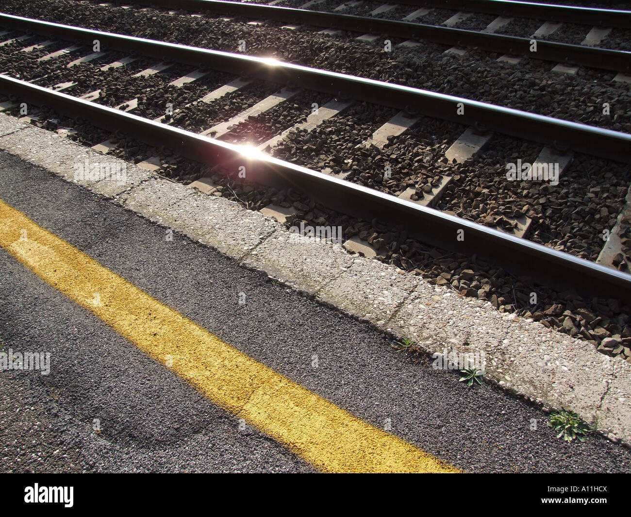 train tracks at station platform Stock Photo - Alamy