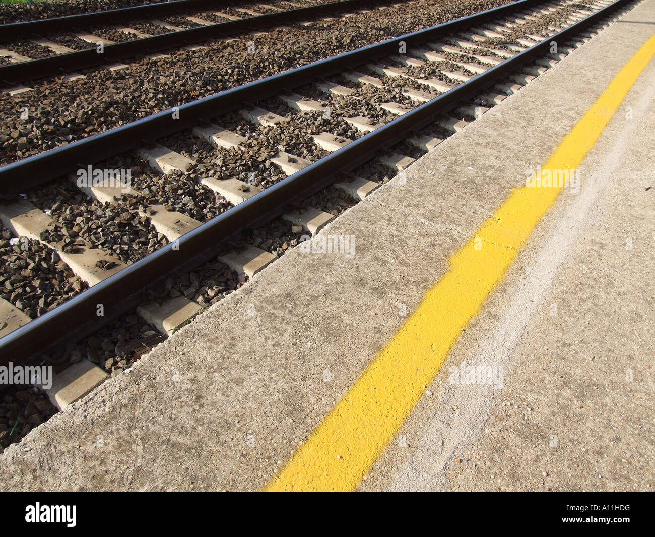 train tracks at station platform Stock Photo - Alamy