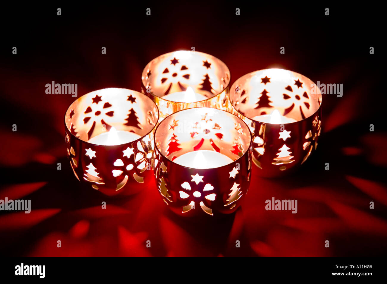 Lit tea lights on a red background with flickering candle light Stock ...