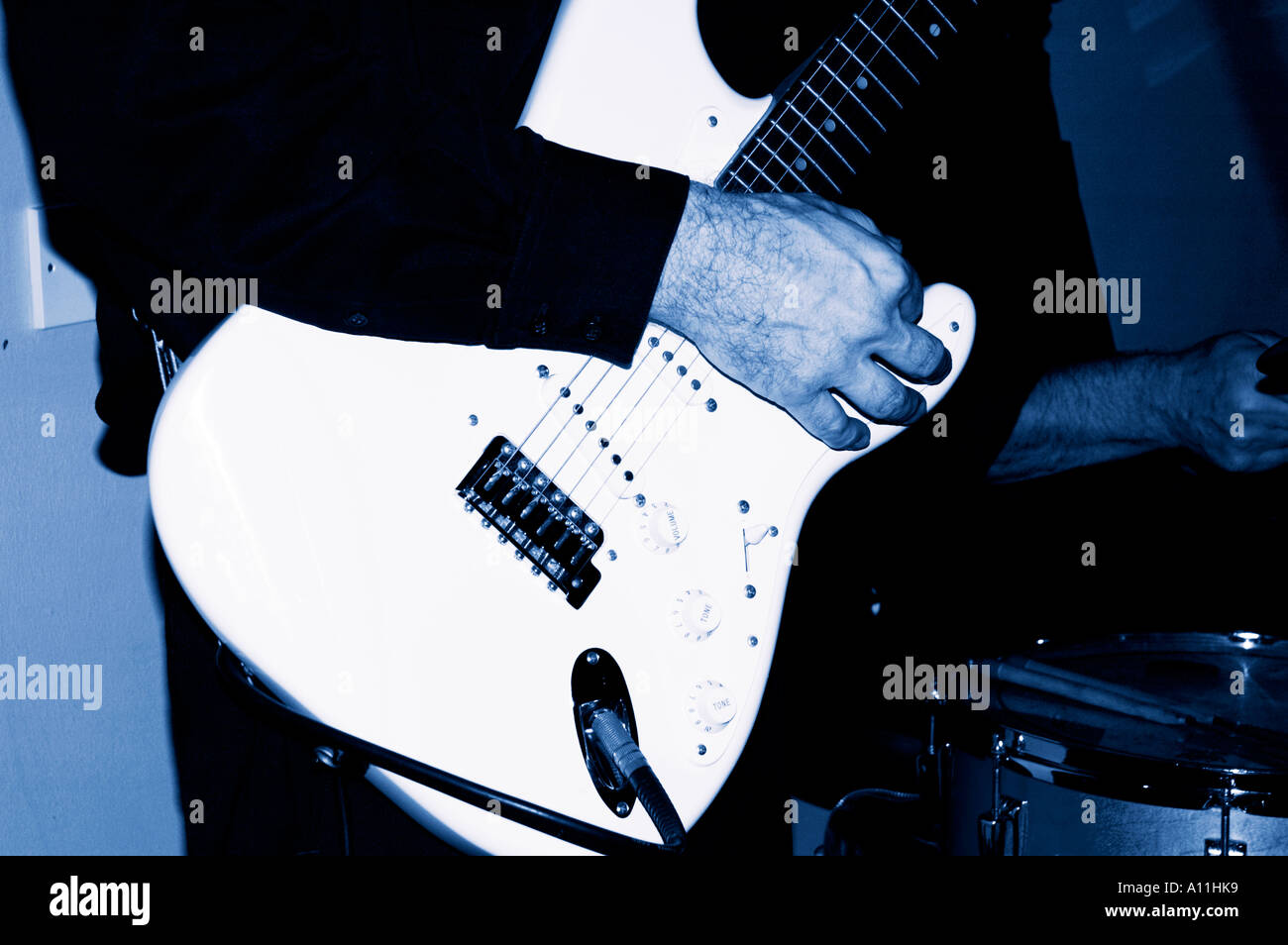 Guitarist playing electric guitar during hi-res stock photography and ...