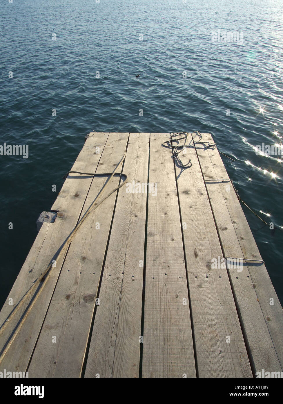 mooring ropes on small jetty by sea Stock Photo - Alamy