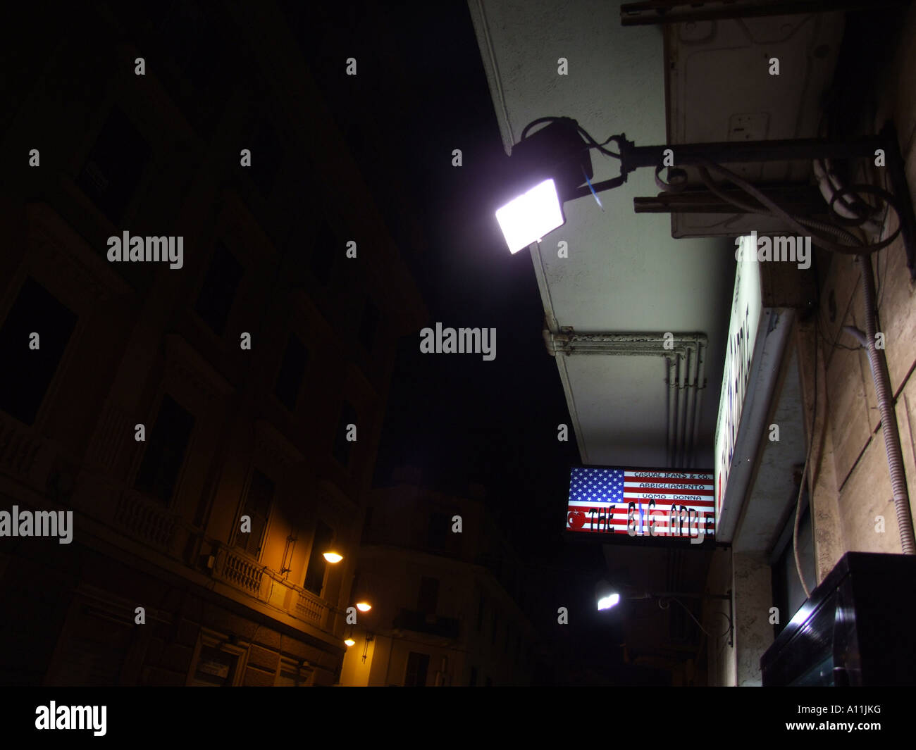 usa flag on shop front at night Stock Photo - Alamy