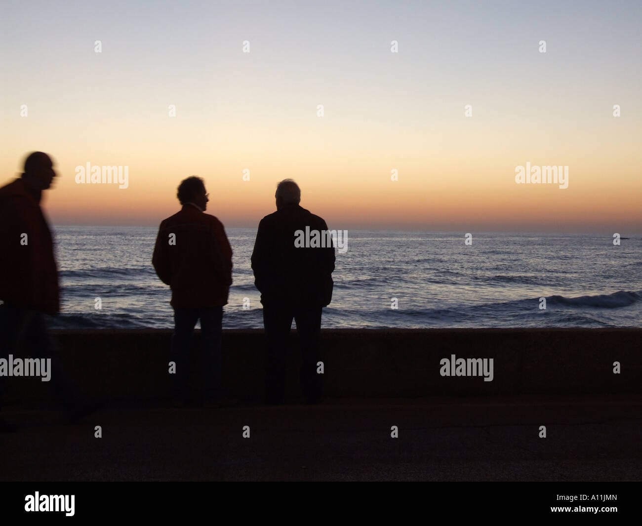 people relaxing by beach promenade at night Stock Photo - Alamy