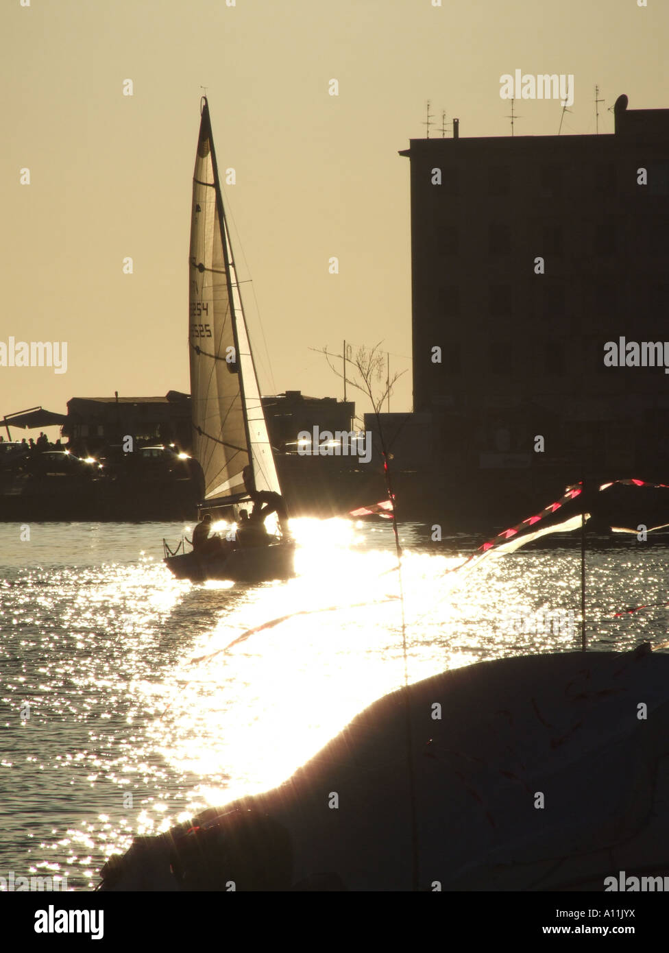 yacht sailing into port Stock Photo - Alamy