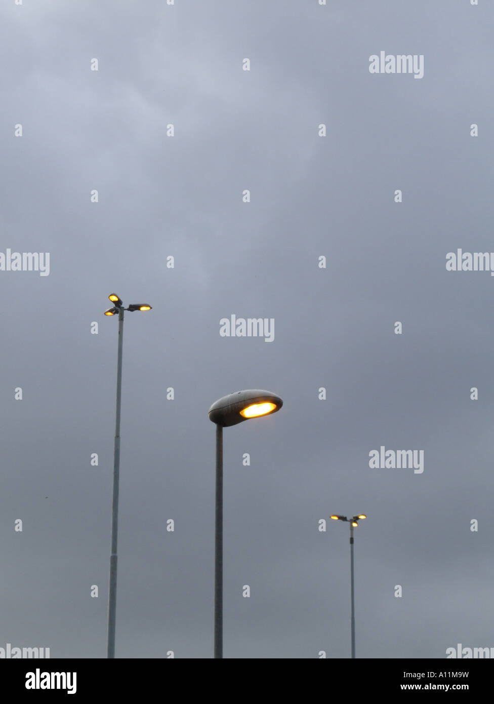 three street lamp posts and dramatic sky Stock Photo - Alamy