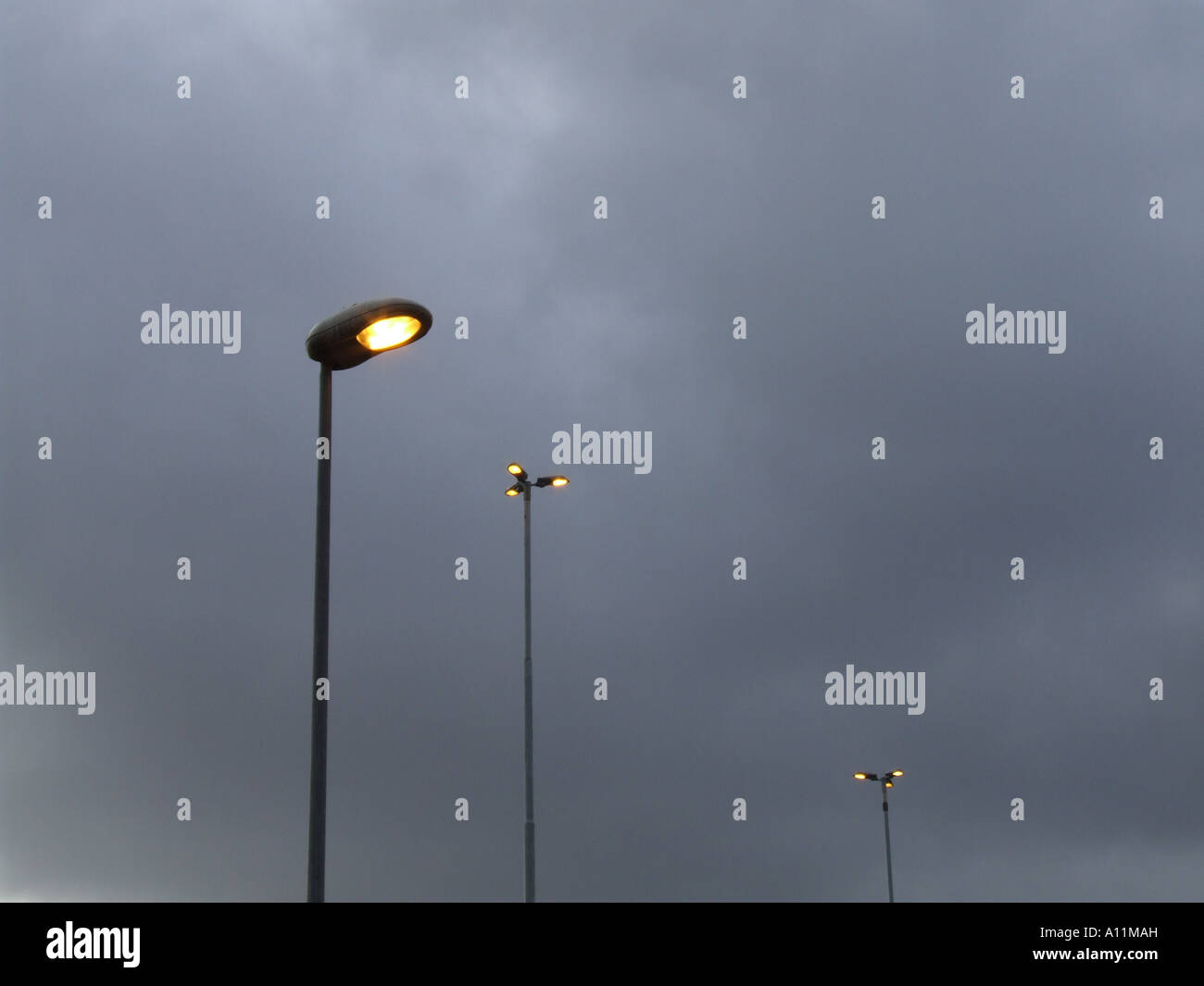 three street lamp posts and dramatic sky Stock Photo - Alamy