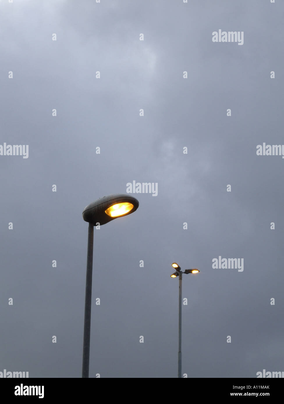 two lamp posts and moody sky Stock Photo - Alamy