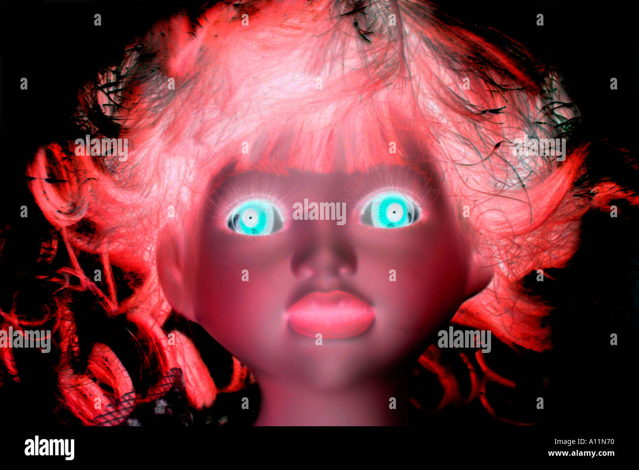 Scary red and black inverted dolls head abstract Stock Photo - Alamy
