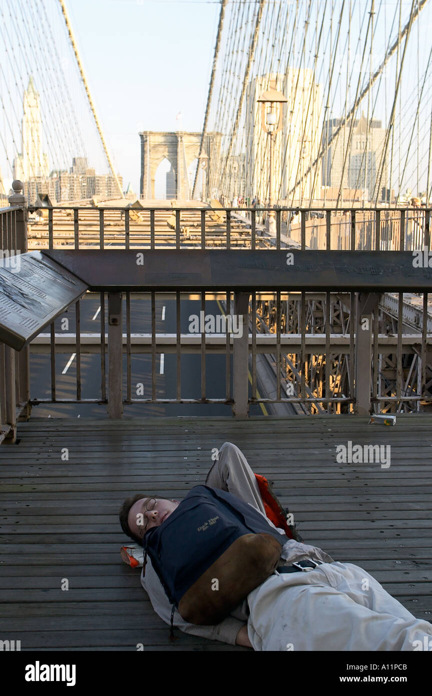 young man sleeping on Brooklyn bridge after a citywide blackout work ...