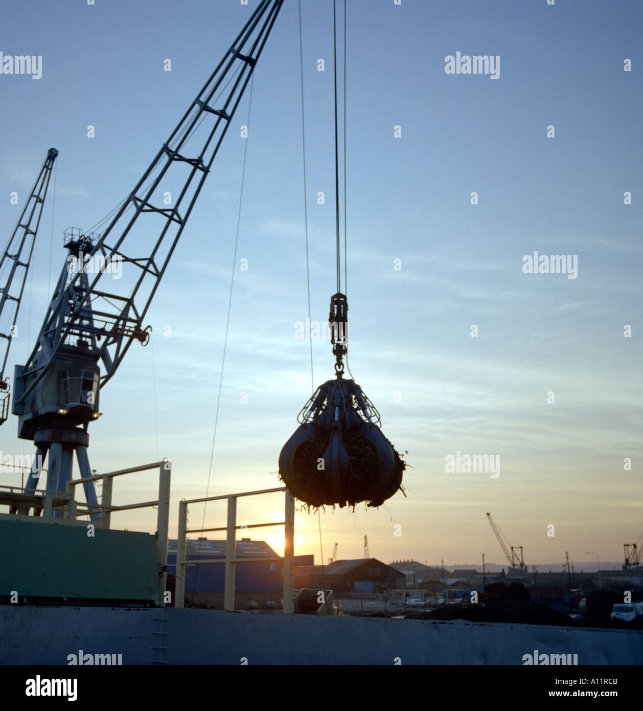 Loading scrap metal into a ships hold Stock Photo - Alamy