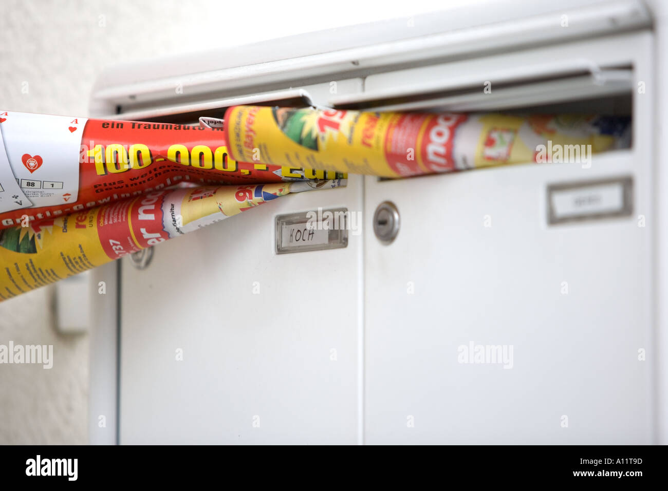 Junk mail stuffed into a post box in Remscheid Germany Stock Photo - Alamy