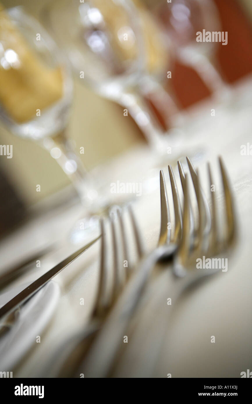 Cutlery on a table in a restaurant with glasses Stock Photo - Alamy