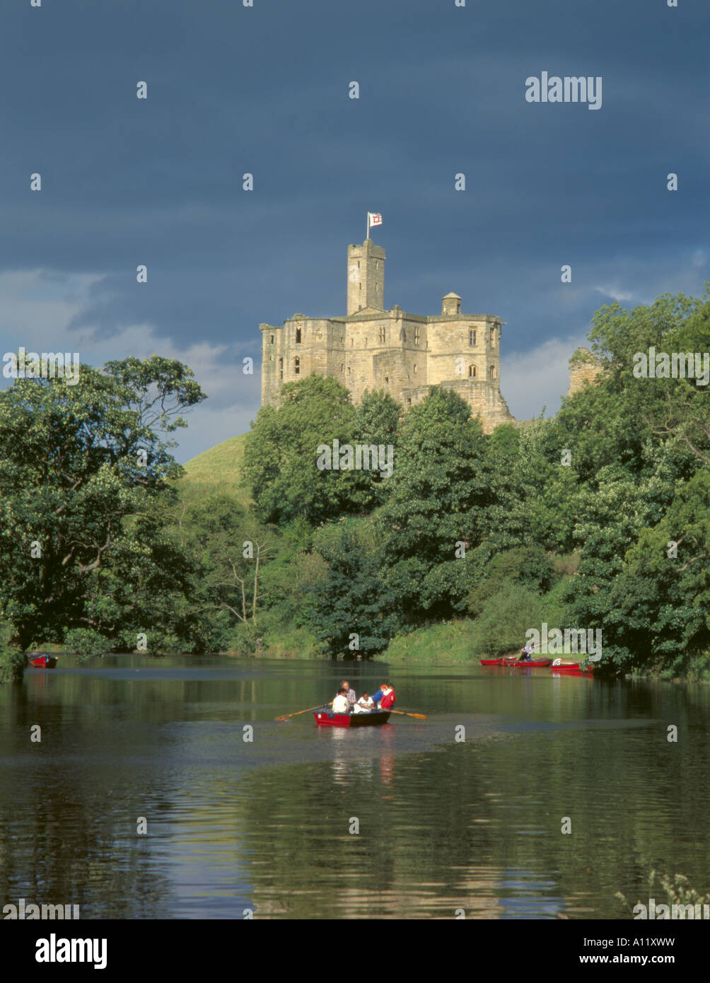 Summer afternoon rowing on the River Coquet with Warkworth Castle ...