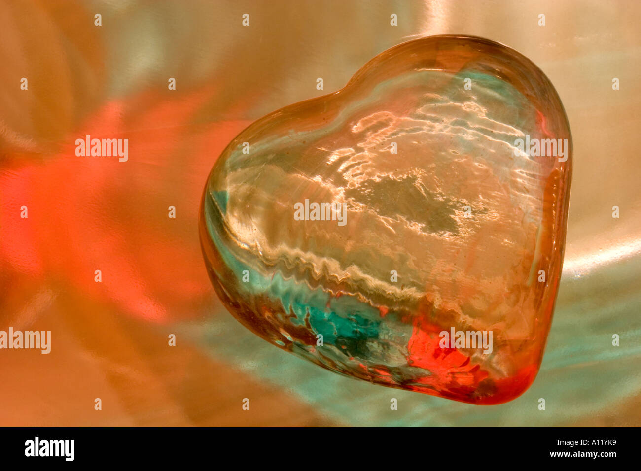 Glass heart on colorful background Stock Photo - Alamy