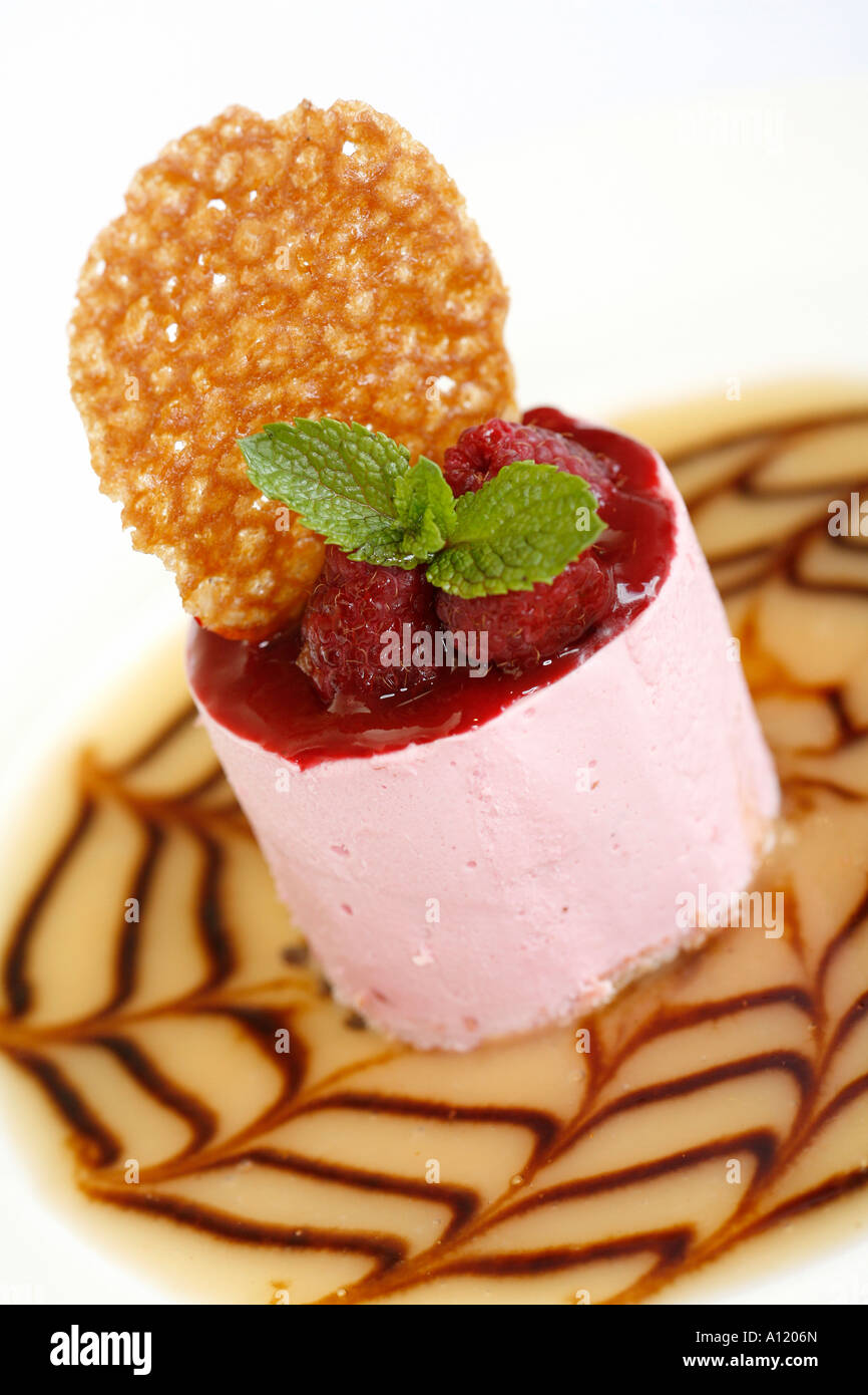 Raspberry bavarois with ginger snap biscuit and peach coulis Stock ...