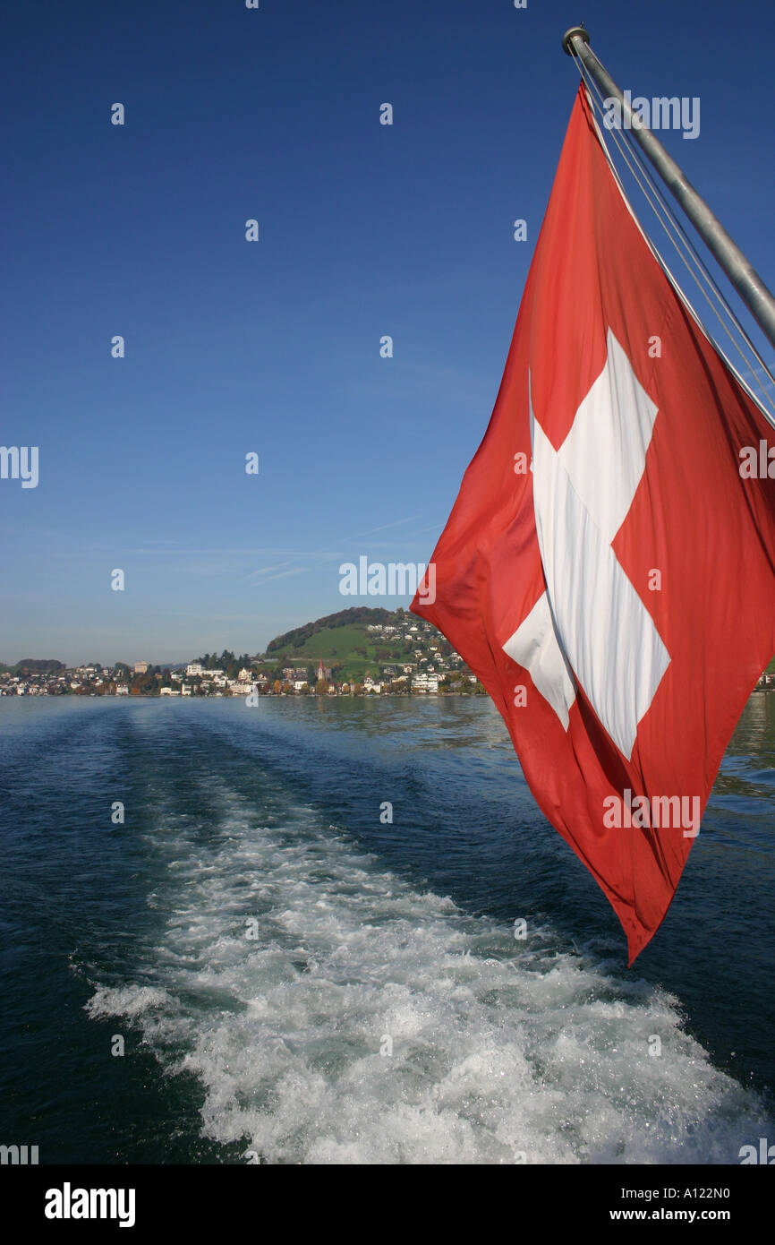 Swiss flag flying at stern of boat on Vierwaldstatter See (lake) with a ...