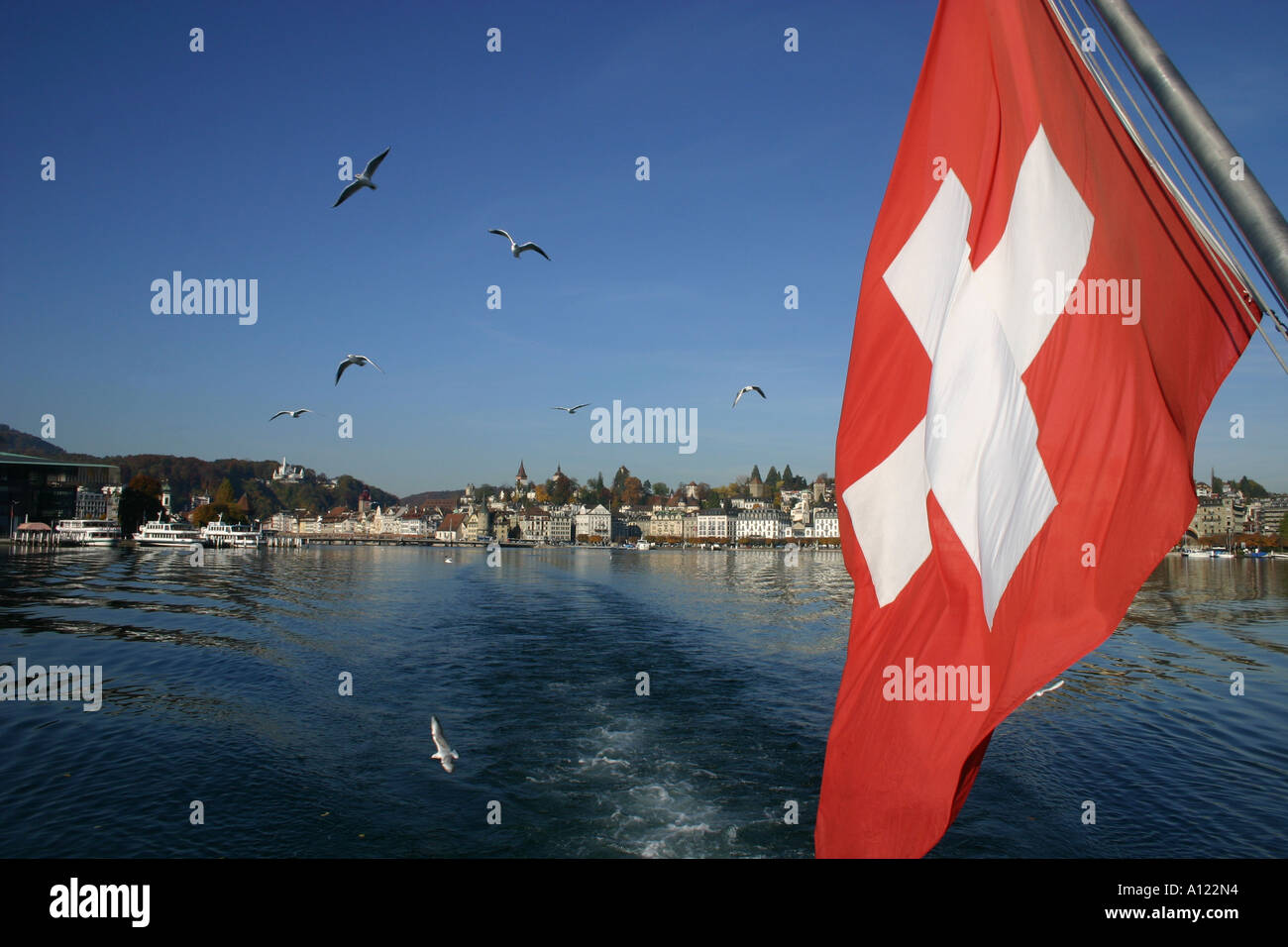 Swiss flag flying at stern of boat leaving Luzern Stock Photo - Alamy
