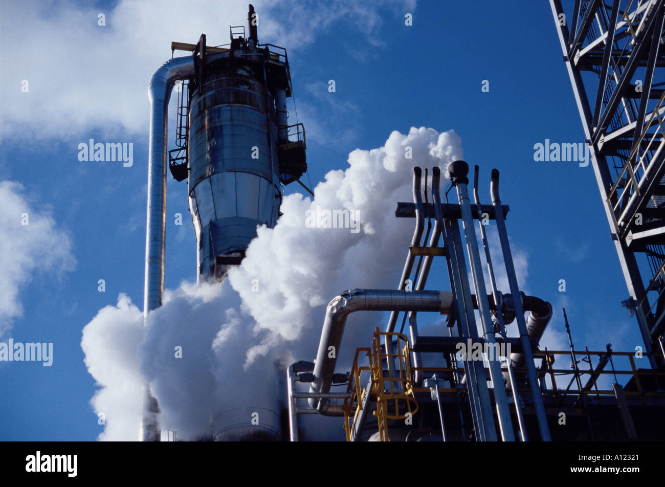 industrial smoke stacks with steam and smoke Stock Photo - Alamy