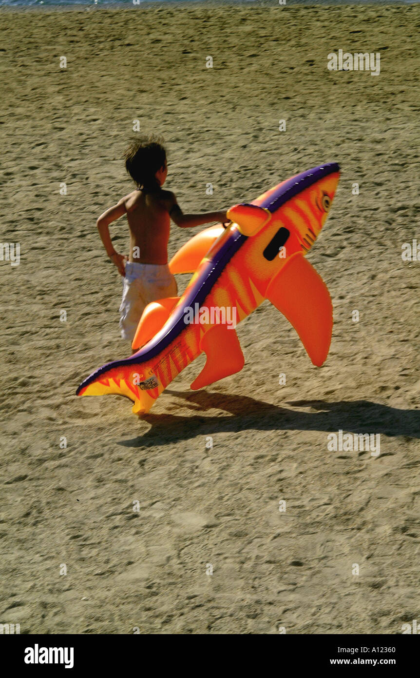 boy with blow up shark on beach Stock Photo - Alamy