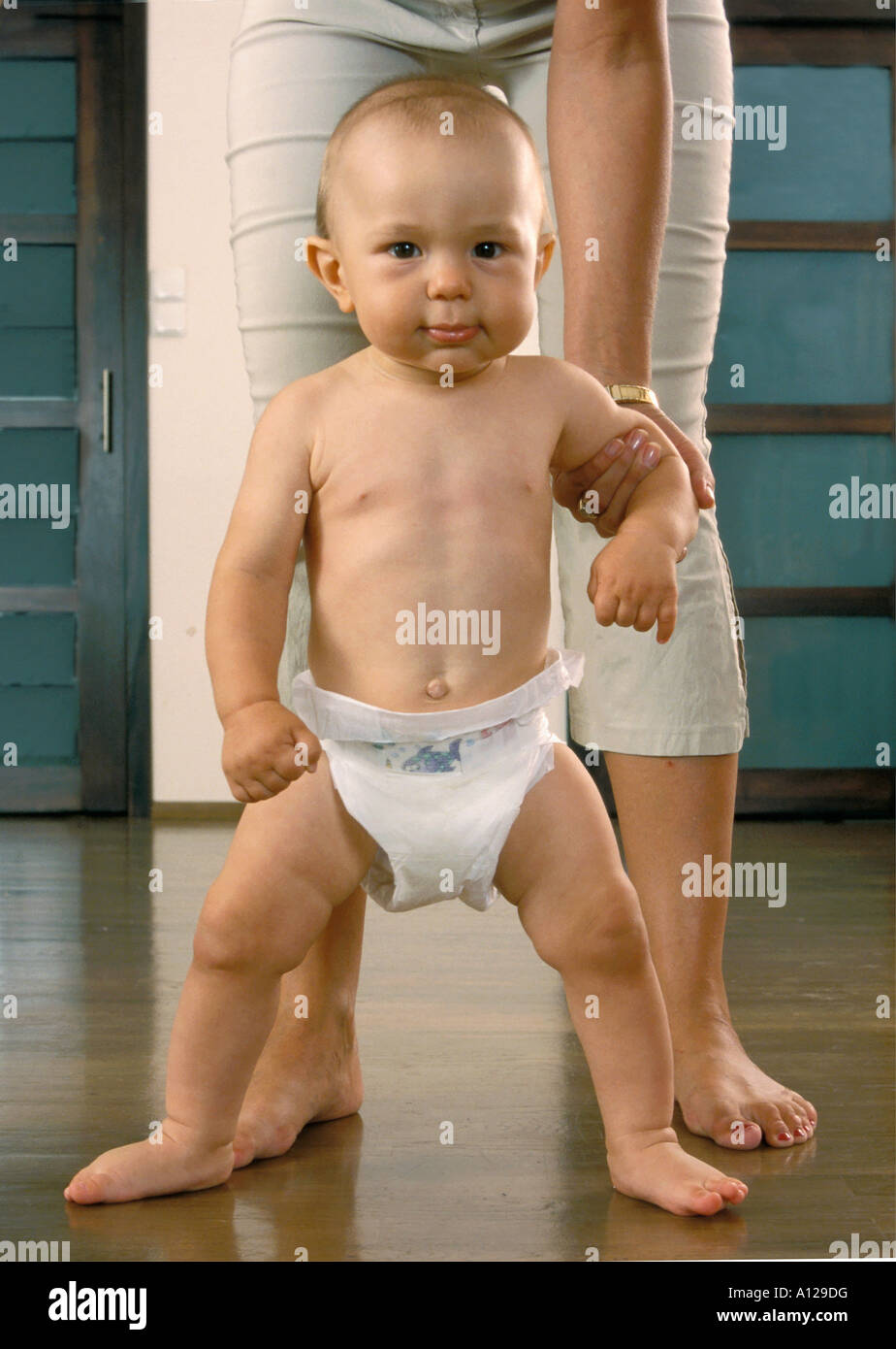 Child first step standing Stock Photo - Alamy